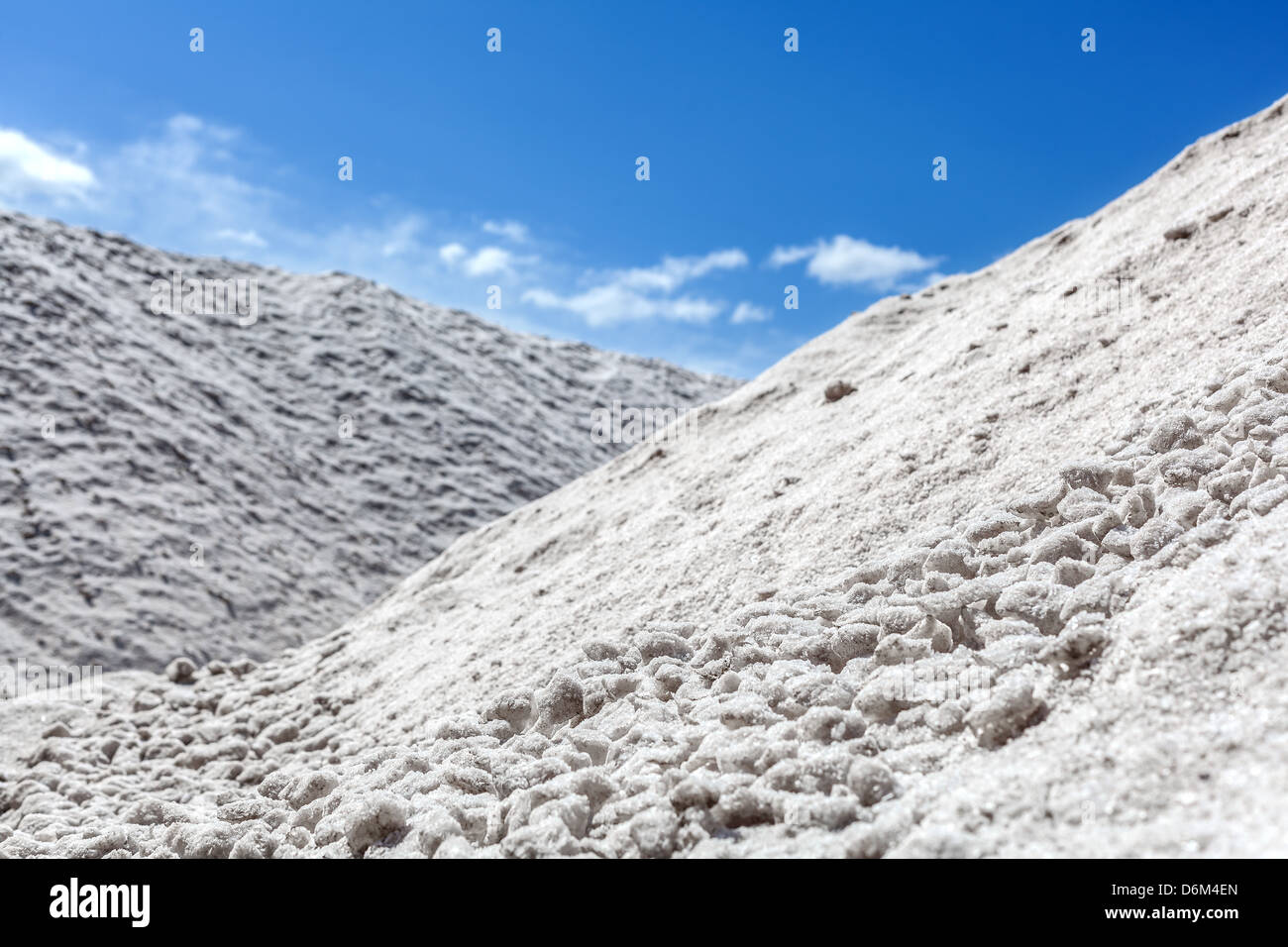 Big pile of freshly mined salt, set against a blue sky Stock Photo - Alamy