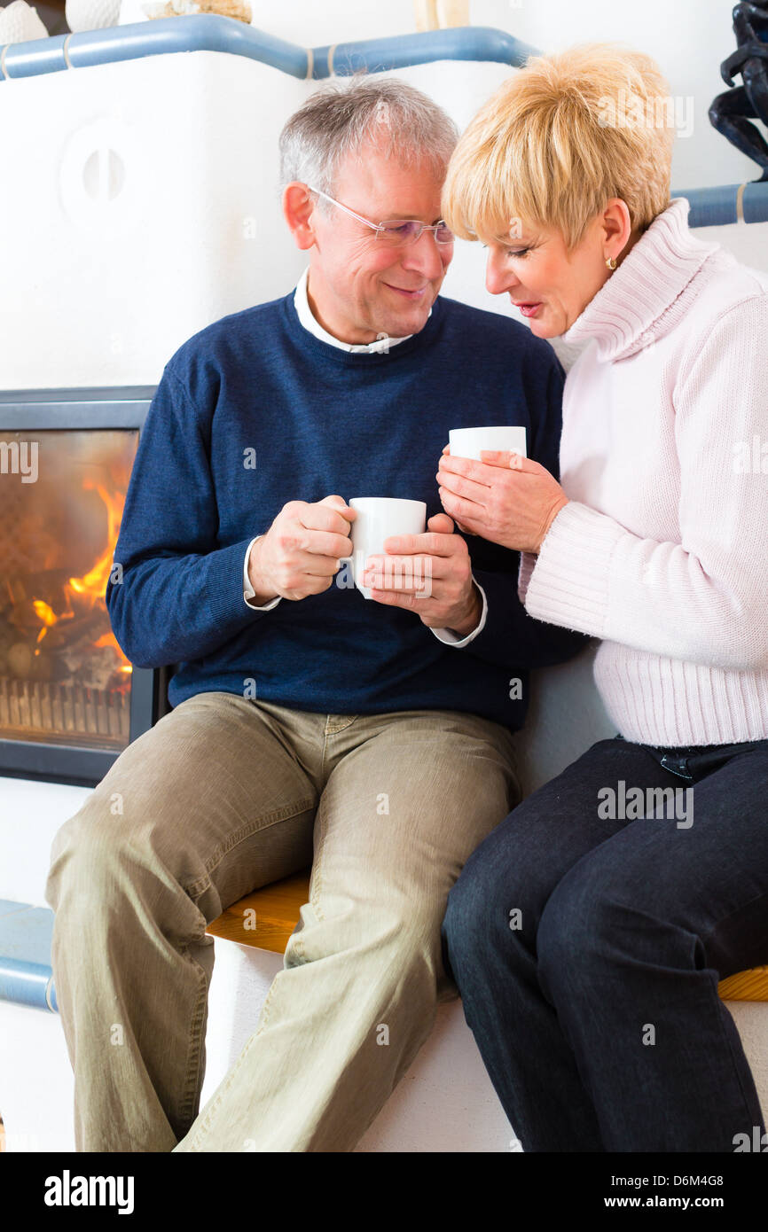 Elderly People Sitting By Fireplace
