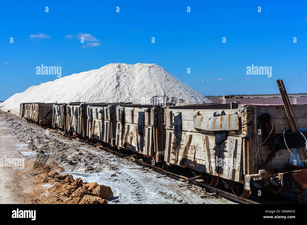 Big pile of freshly mined salt, set against a blue sky Stock Photo - Alamy
