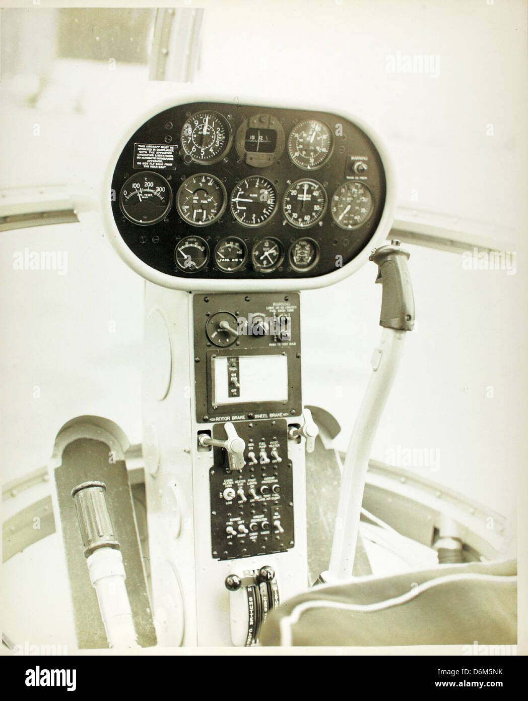 This image features a close-up of a helicopter instrument panel ...