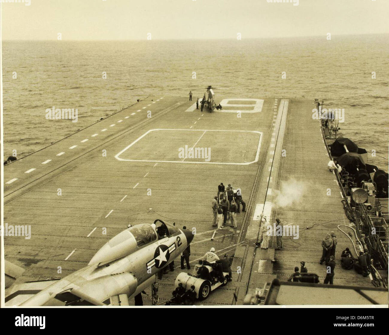This image shows helicopter operations aboard the USS Hancock (CV-19 ...