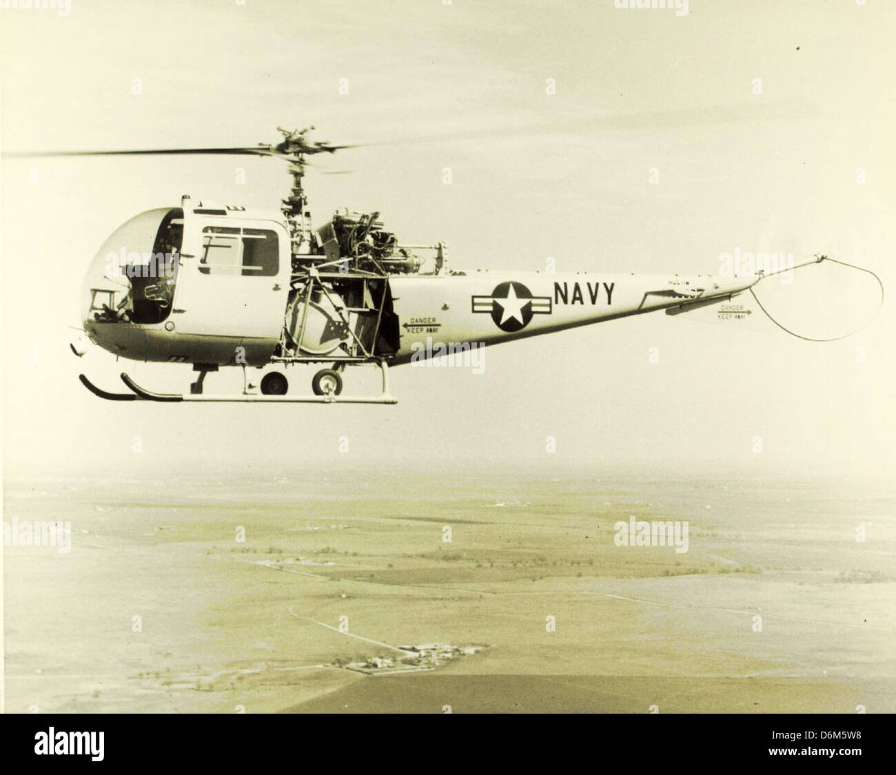 This photograph captures a Bell helicopter in flight, showcasing the ...