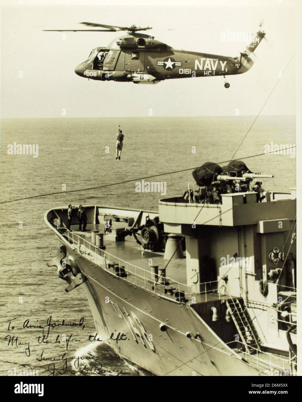 This photo shows a HC-1 helicopter with a person in a sling being ...