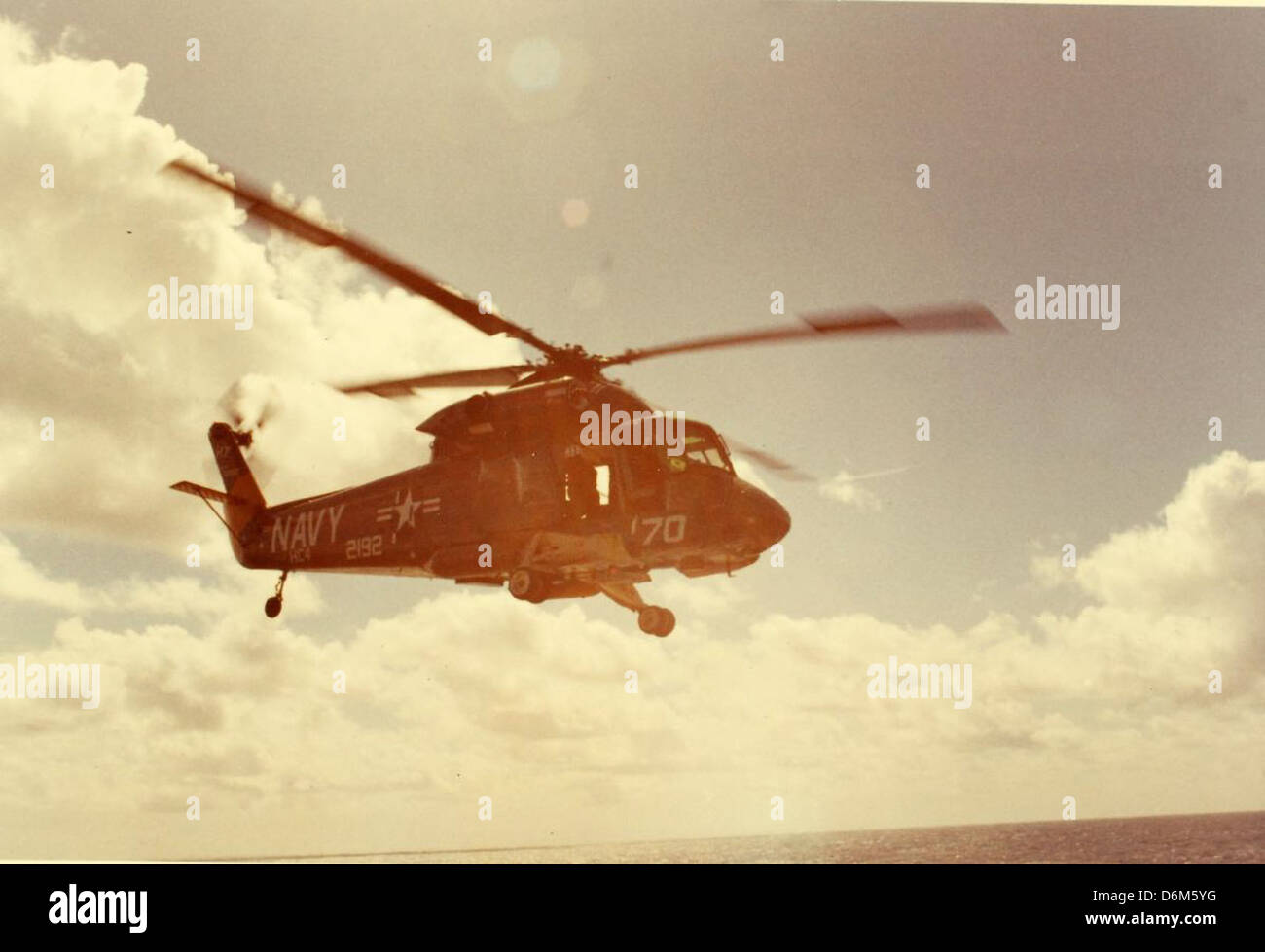 This photograph shows an HC-4S H-2 helicopter landing aboard a ship ...