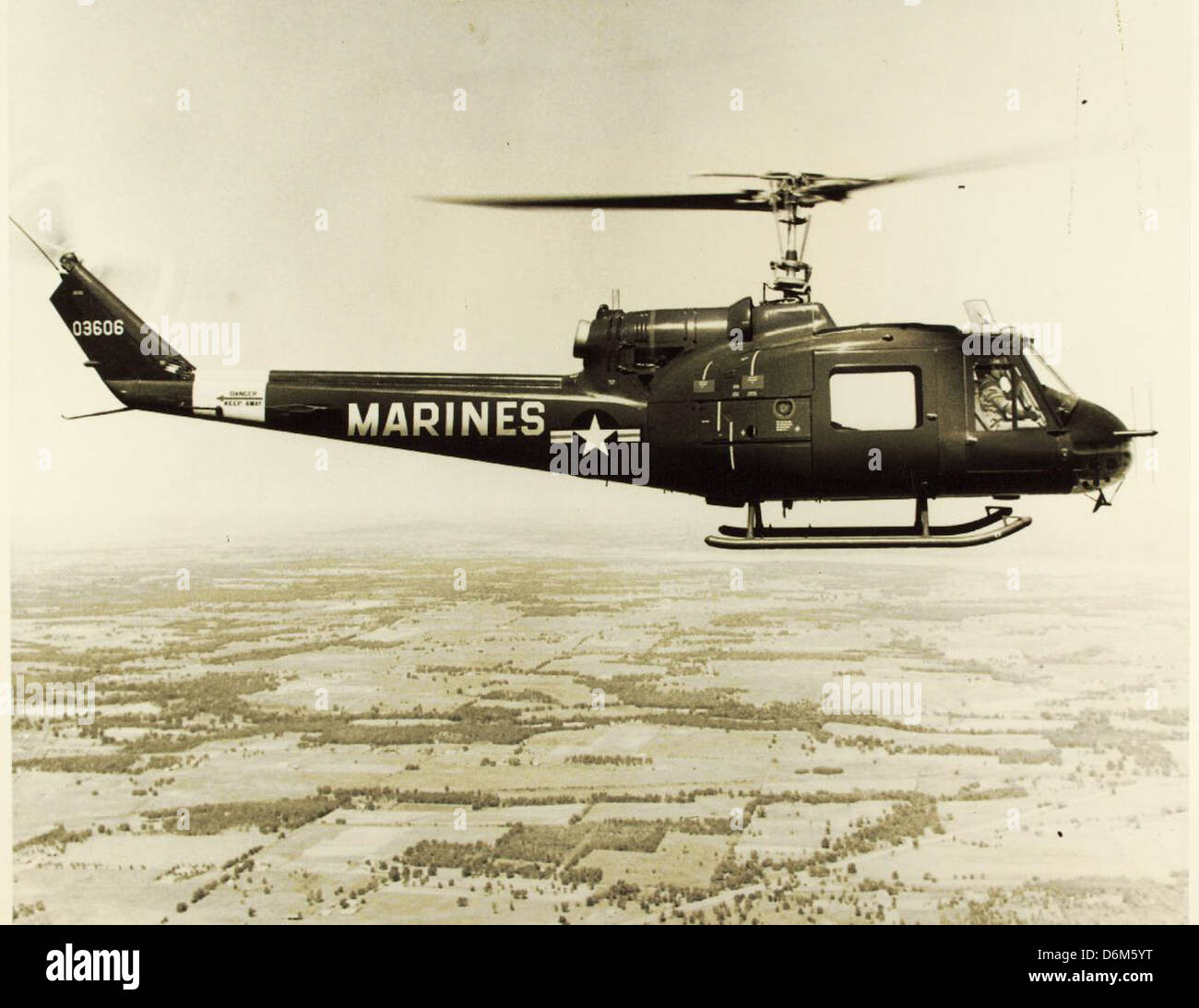 This photo features a Bell HU-1B helicopter, known as the UH-1 Iroquois ...