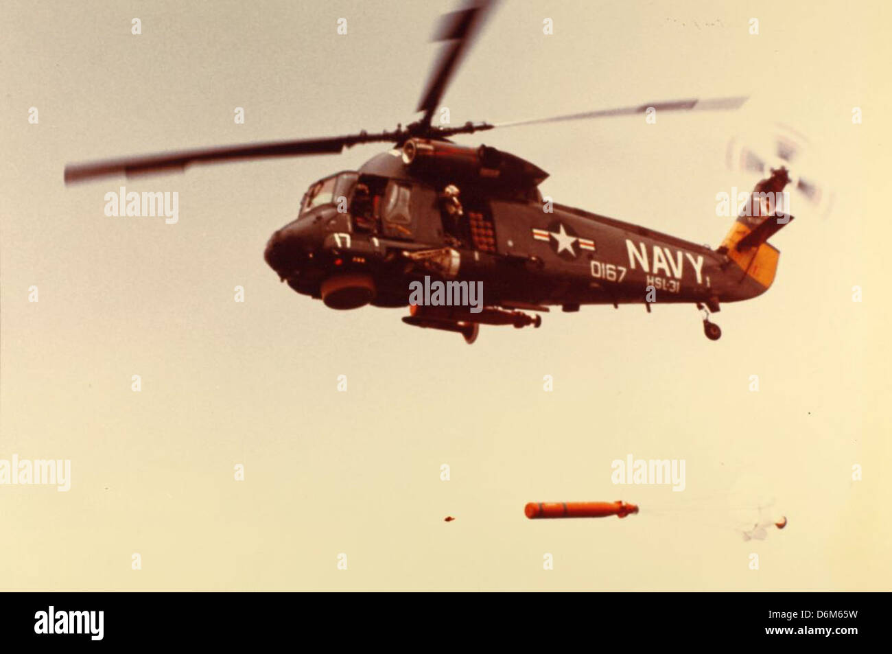 The H-2 helicopter from HSL-31 is seen in operation, dropping a ...