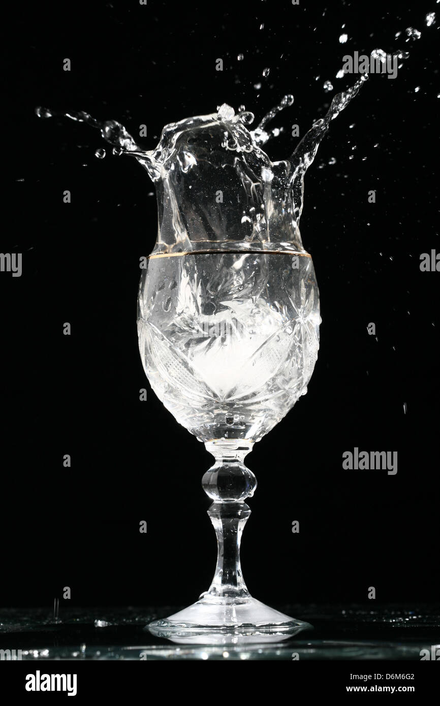 alcohol splash on black background Stock Photo - Alamy