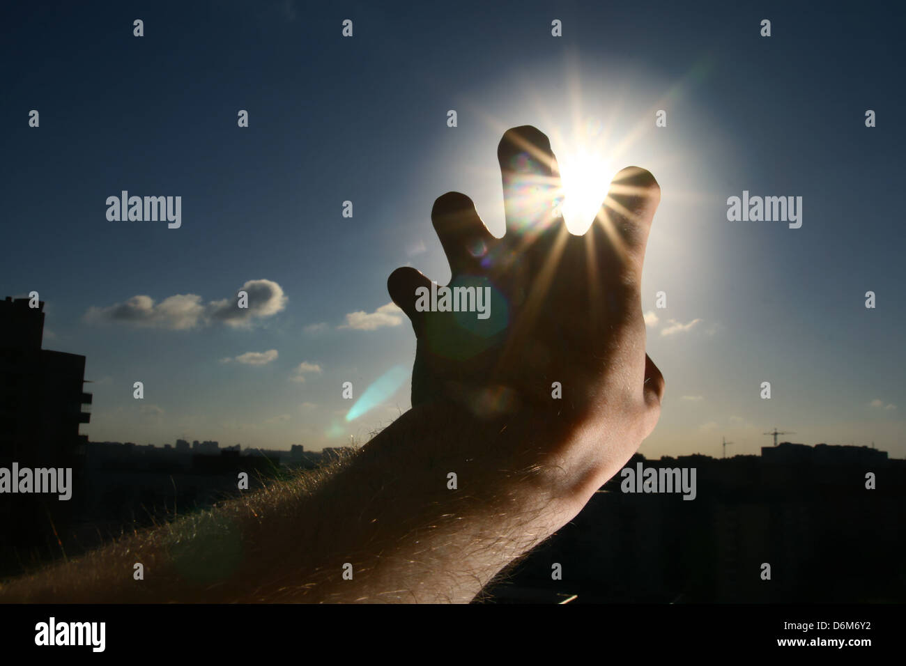 hand take the sun city in dark Stock Photo - Alamy