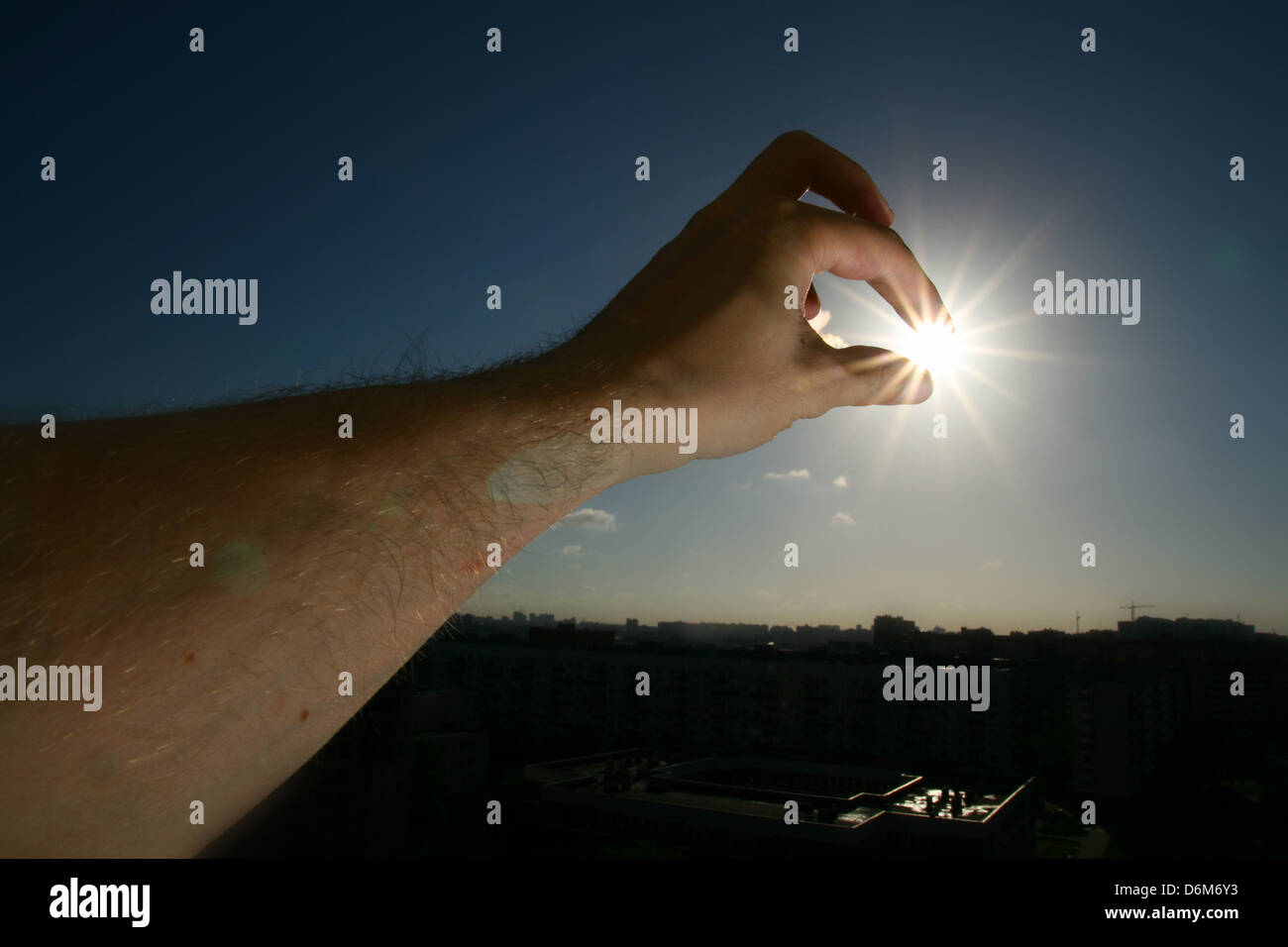 hand take the sun city in dark Stock Photo - Alamy