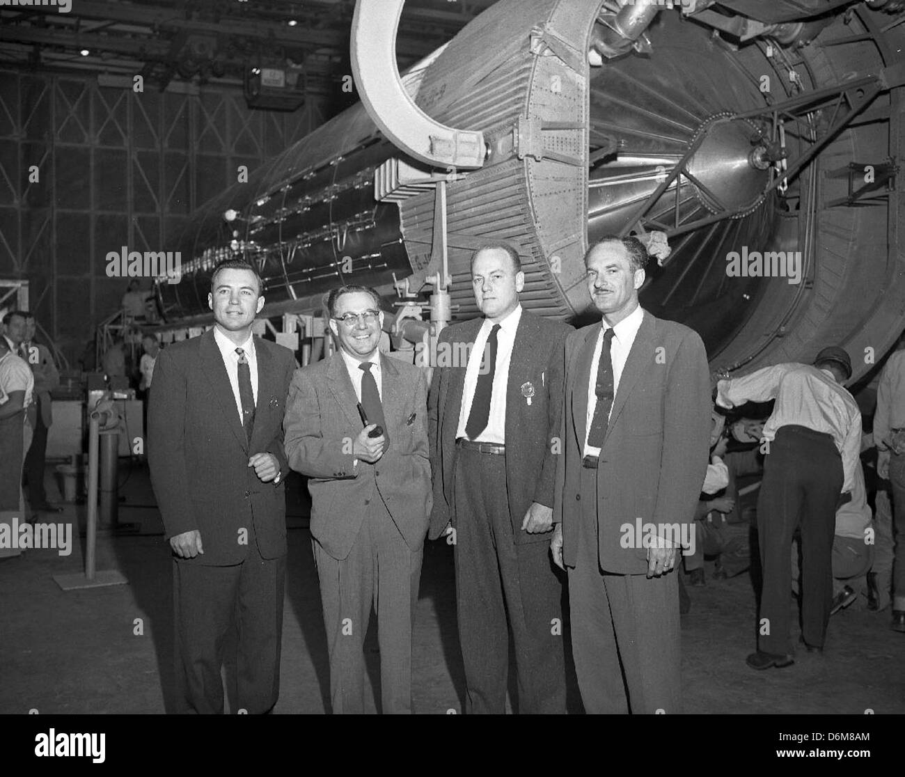 This image shows four VIPs standing while observing the movement of a ...