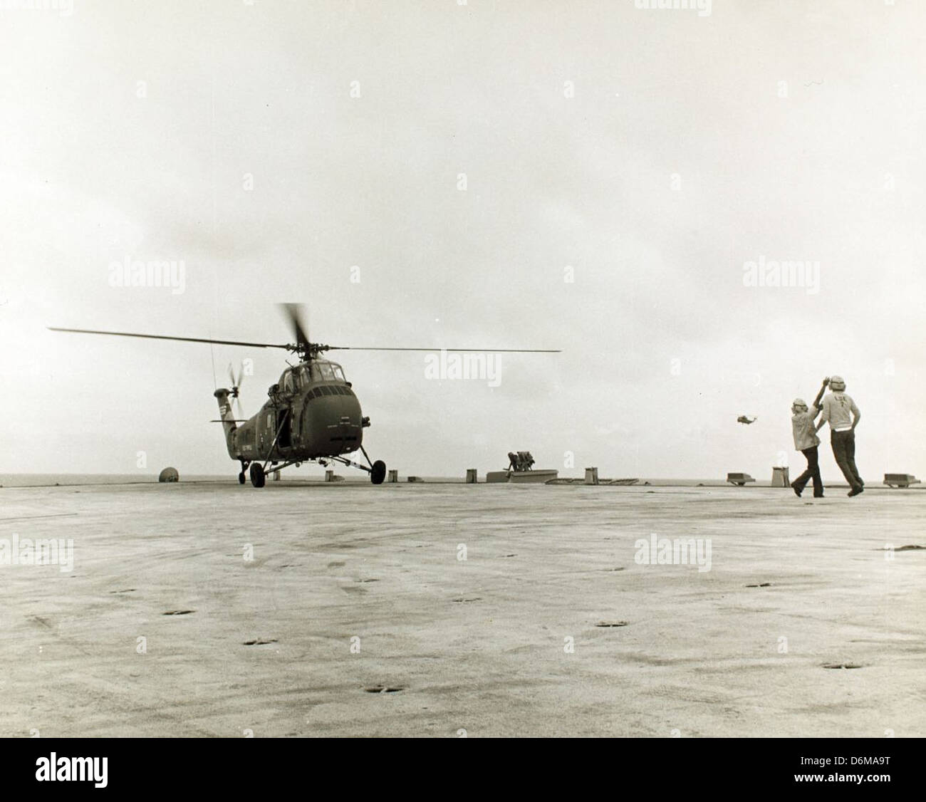 This photograph captures the landing of an H-34 helicopter, a versatile ...
