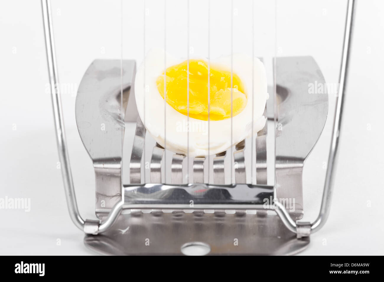 Cutted egg on cutter, closeup on white Stock Photo - Alamy
