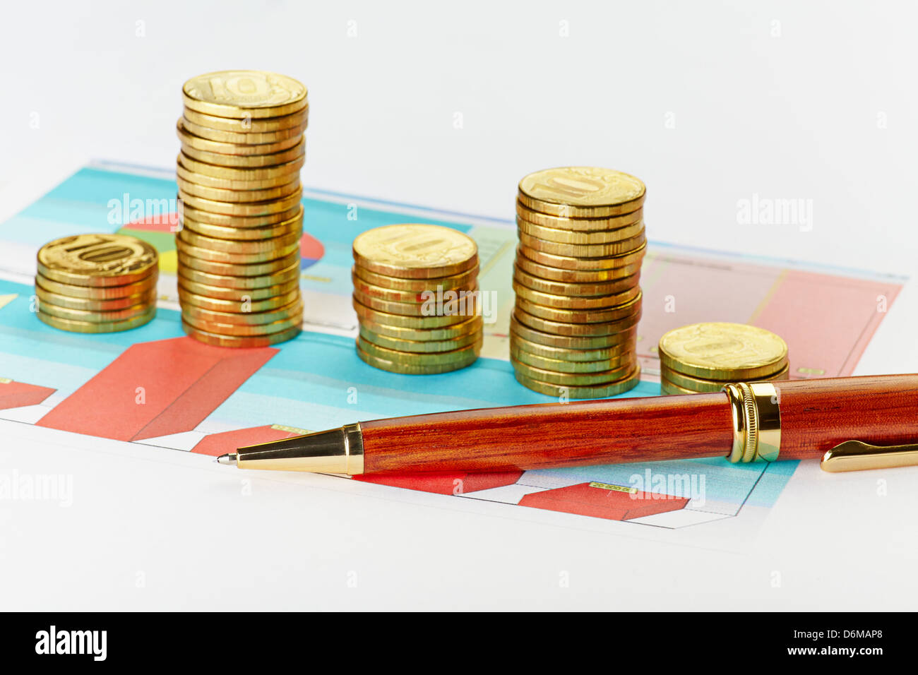 Coin stacks with financial graph hi-res stock photography and images ...