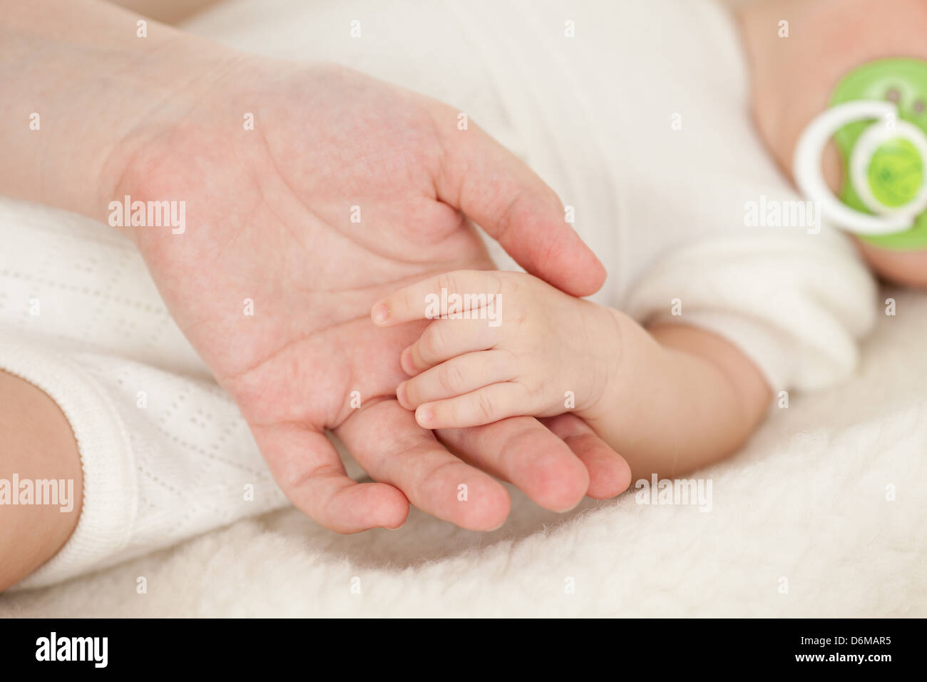 Hand holding sleeping babys hand people hi-res stock photography and ...