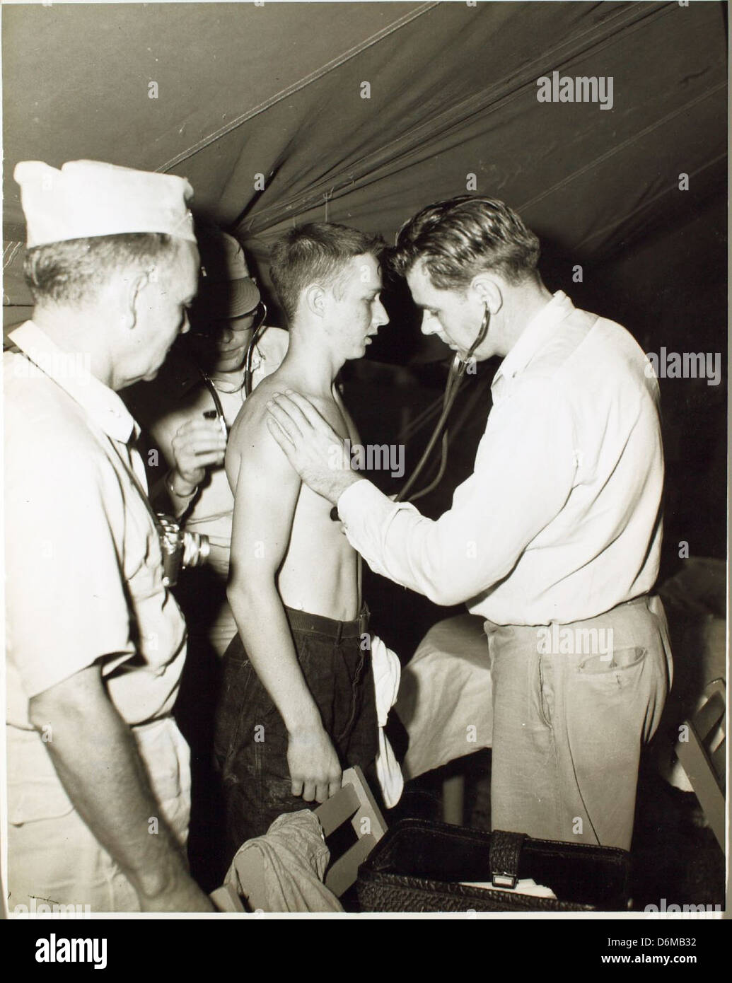This photo from 1955 depicts victims of Hurricane Janet being examined ...