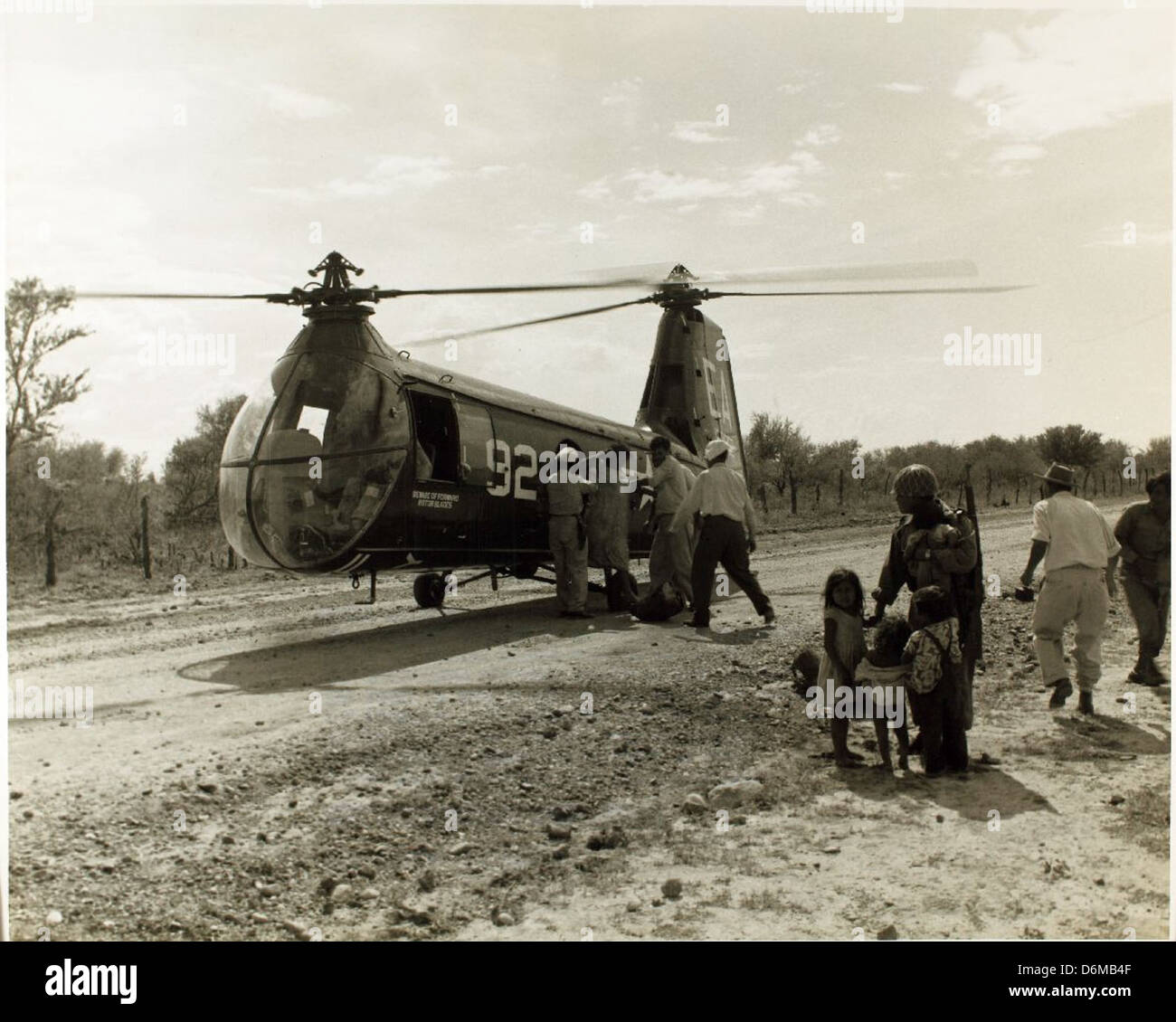 This image depicts a U.S. Navy helicopter from the USS Saipan rescuing ...