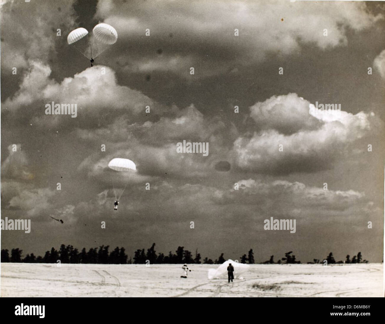 This historical photograph shows parachutists landing in an unspecified ...