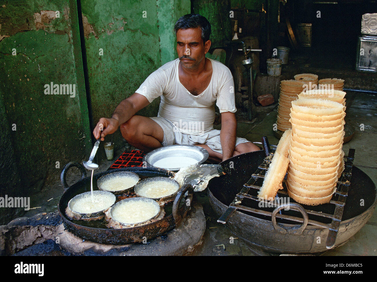 Man cooking local sweets ( India Stock Photo - Alamy