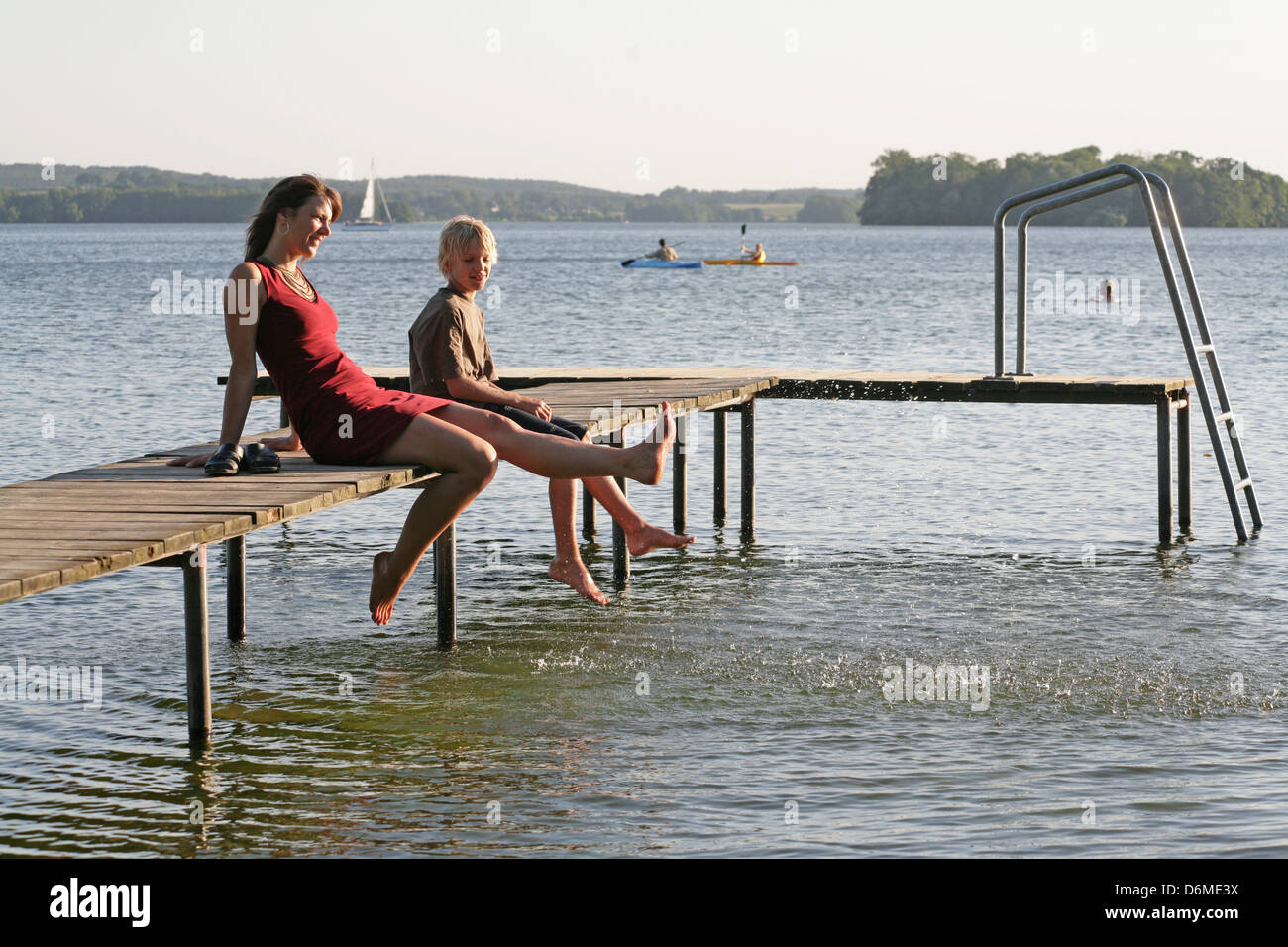 Ploen, Germany, a young woman relaxing with her son on a jetty Stock Photo - Alamy