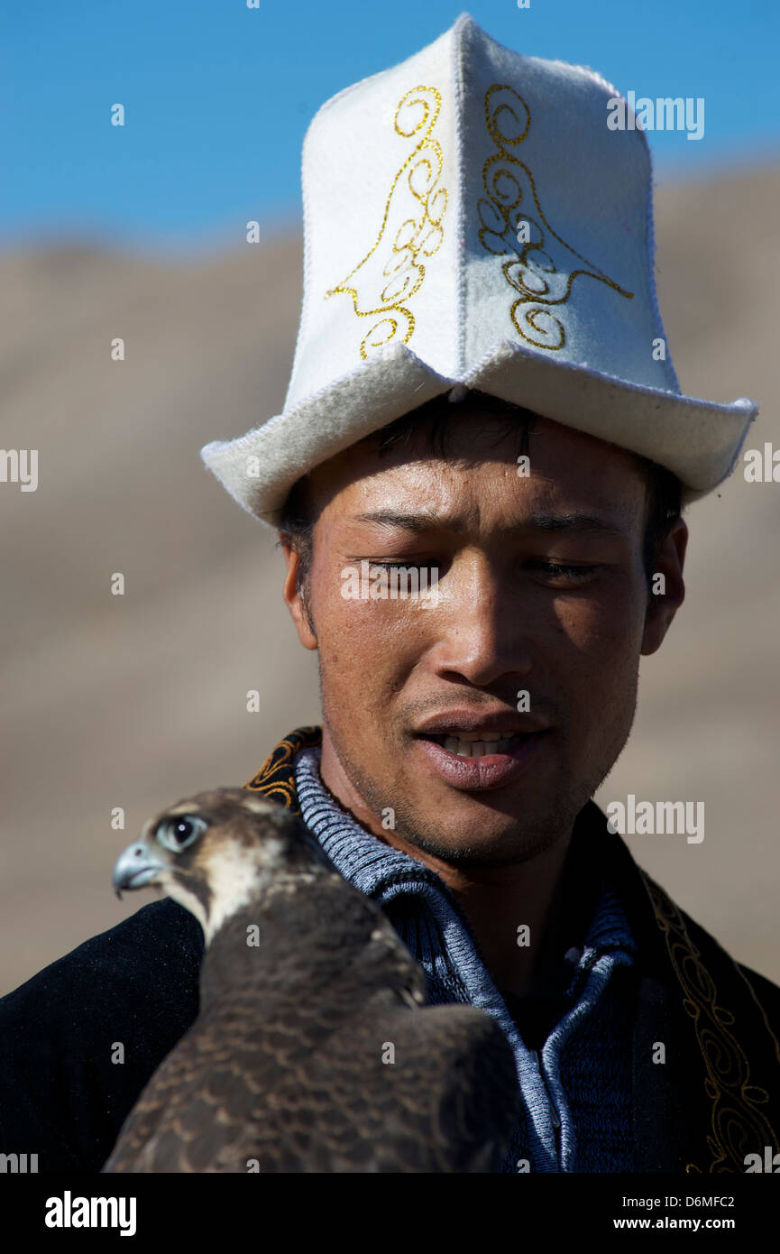 kalpak wearing boy and his bird Stock Photo - Alamy