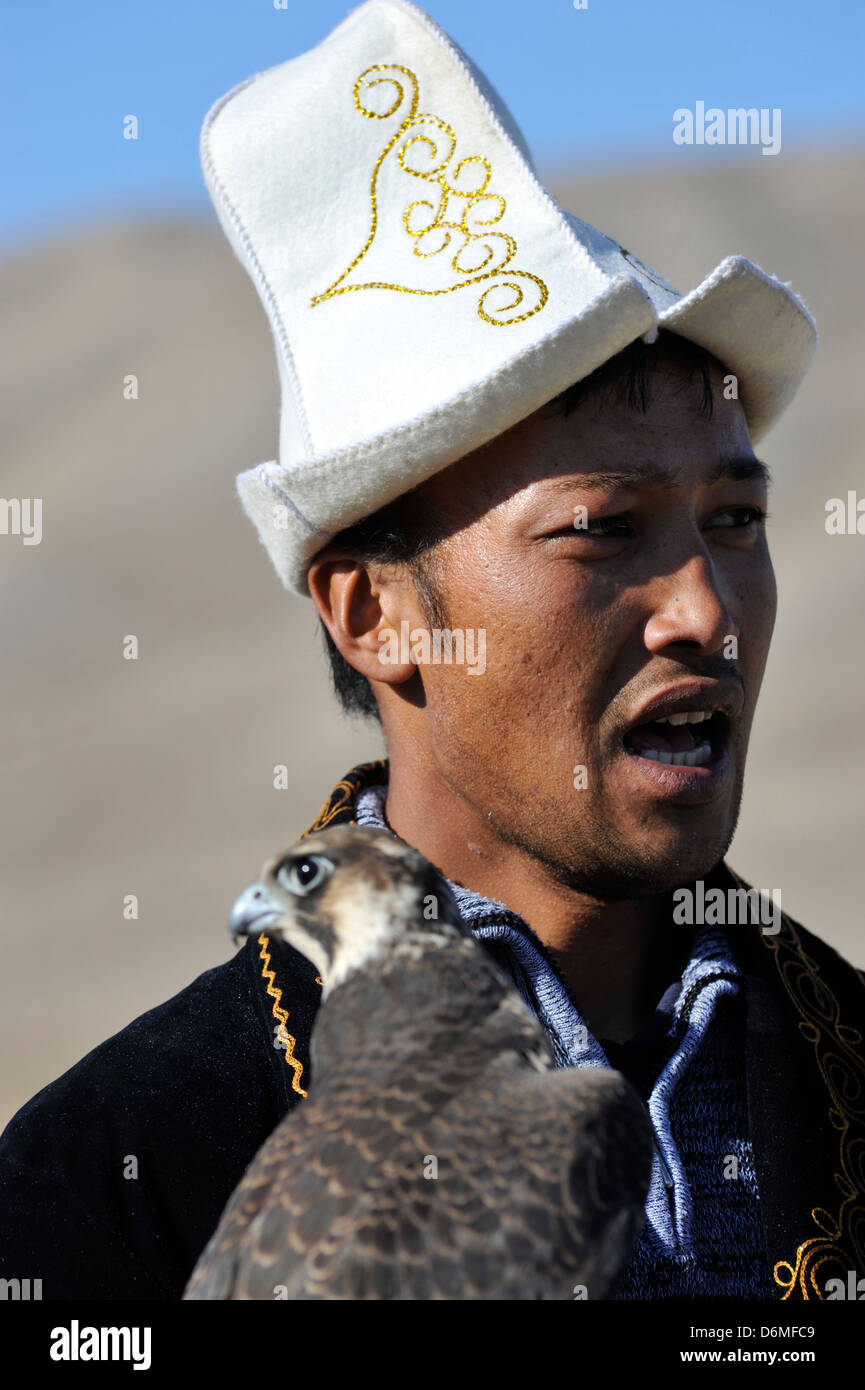 kalpak wearing hunter and his bird Stock Photo - Alamy