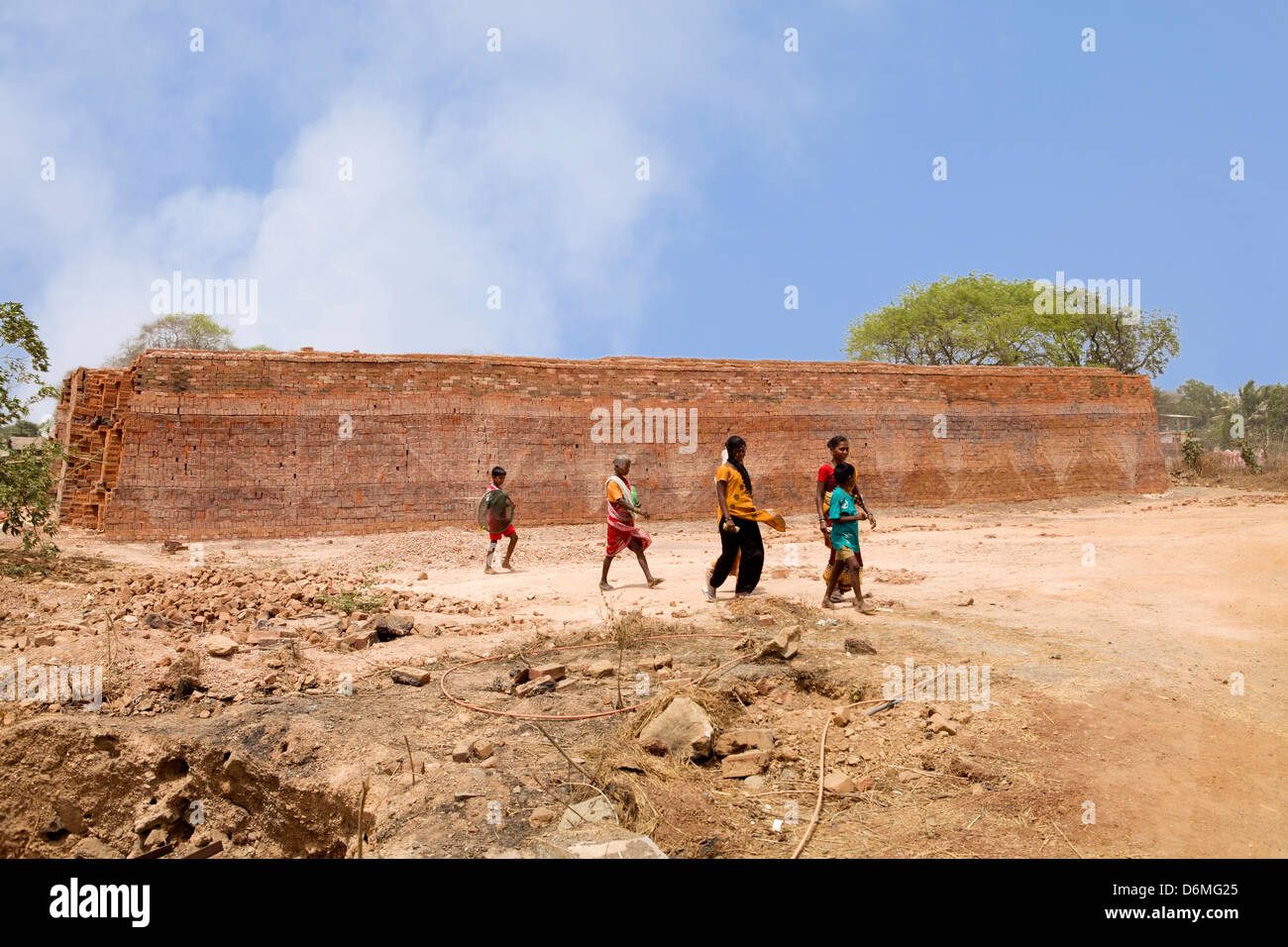 Brick manufacturing business with workers walking by Stock Photo - Alamy