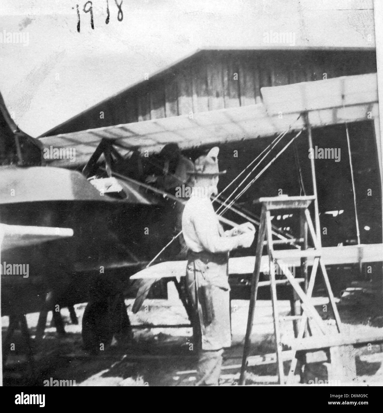 Jim Hester is shown working on an unidentified speed record plane, a ...