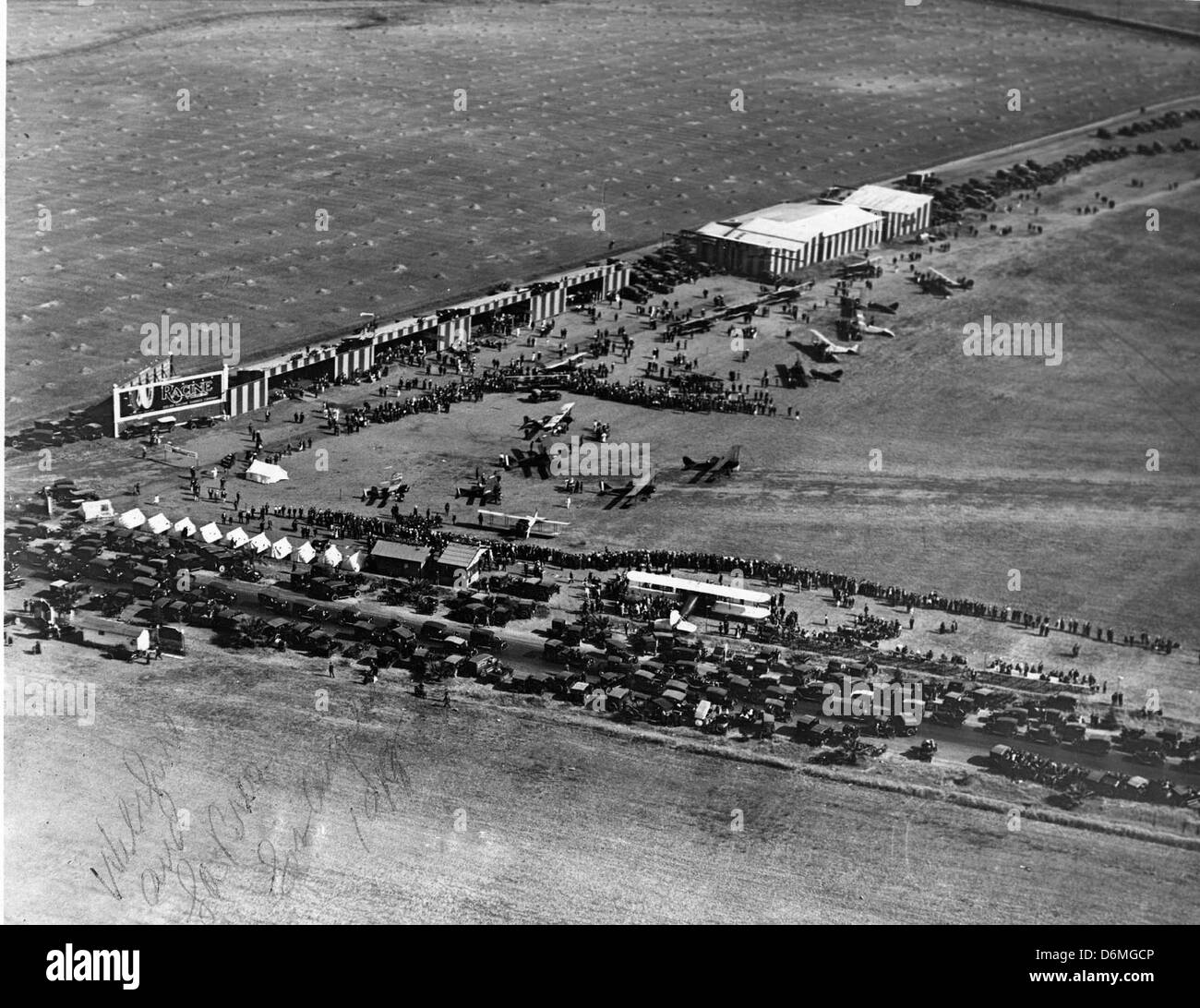 This aerial view captures an air show at Rogers Field, featuring ...