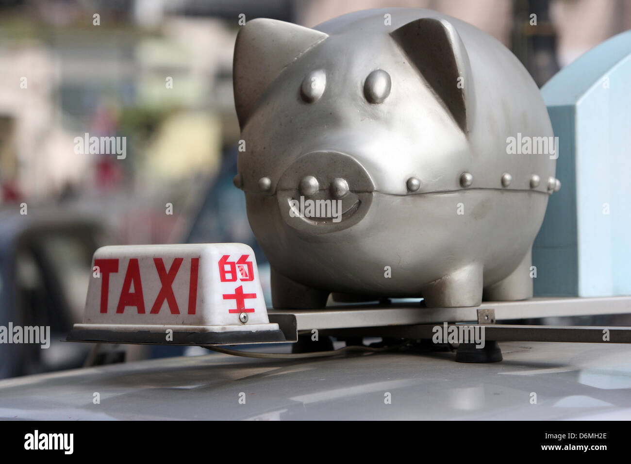 Hong Kong, China, plastic pig on a taxi roof Stock Photo - Alamy