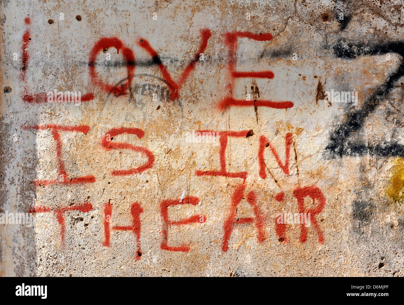 Love is in the air graffiti on a stone wall Stock Photo - Alamy