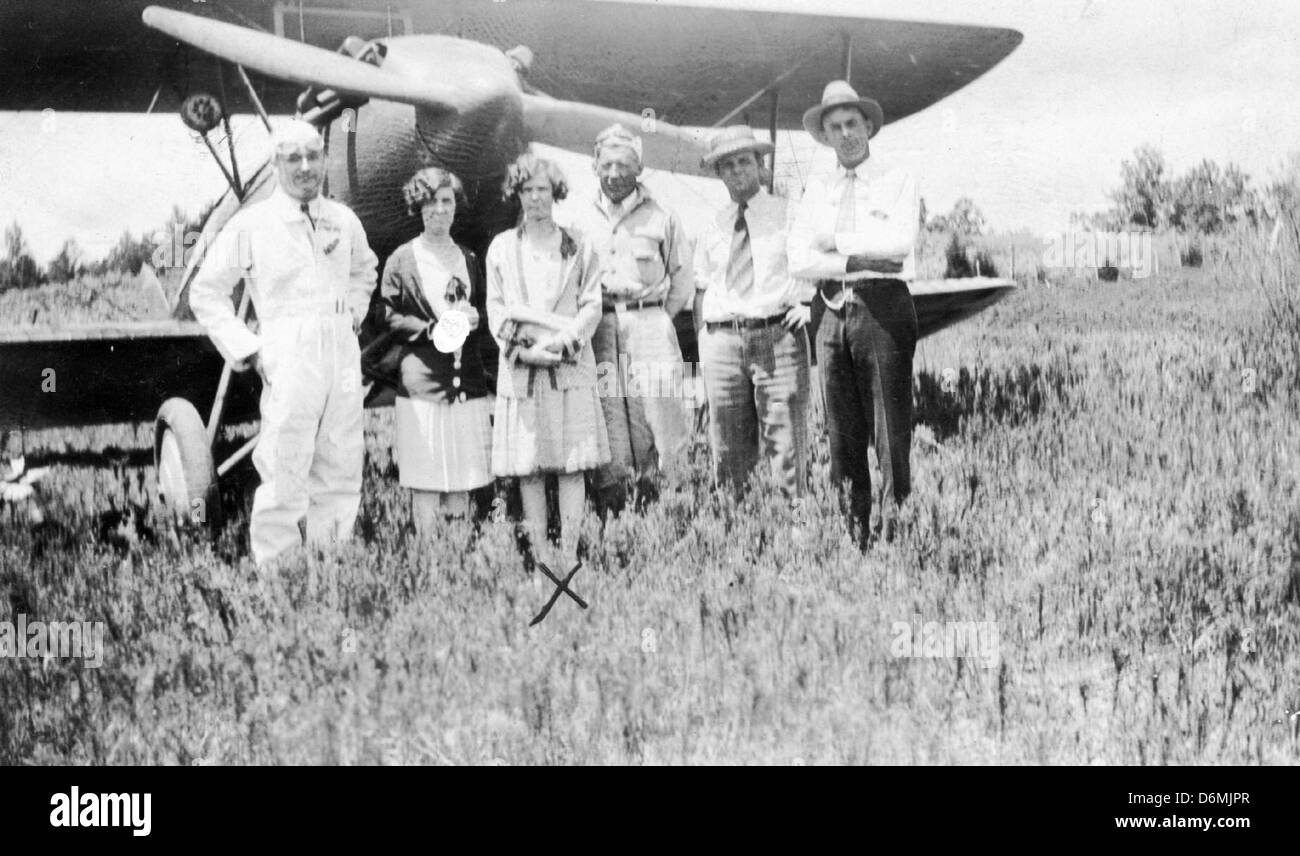 This historical image shows Robert Mitchell with a biplane in Minnesota ...
