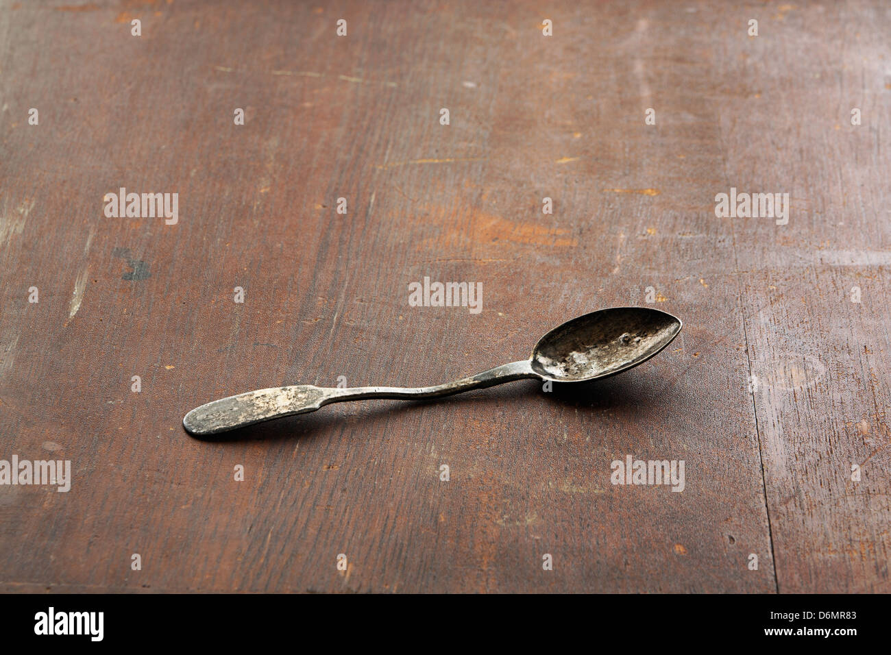 Old silver tea spoon on wooden table Stock Photo - Alamy