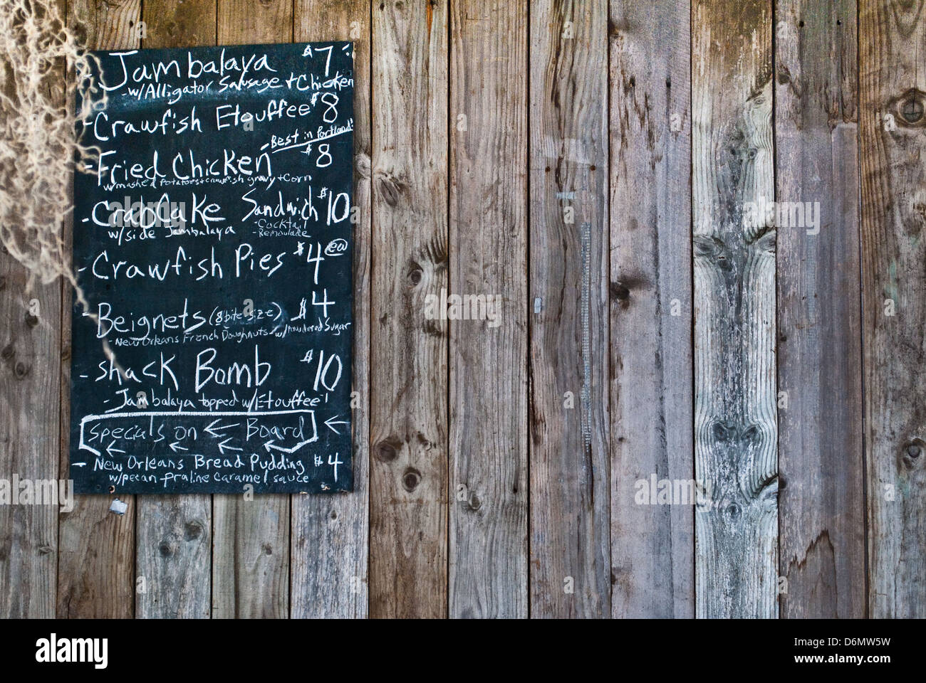 Cajun Creole Menu Written on Chalkboard Mounted to Wooden Wall at ...