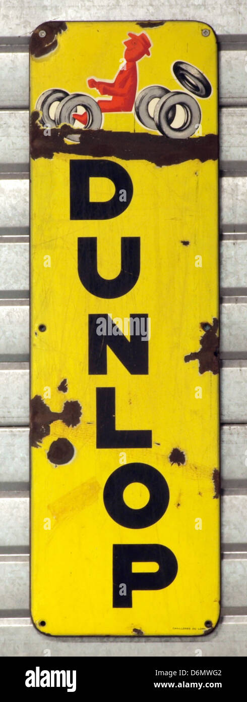 A Dunlop enamel advertising sign displayed at the Den Hartog Ford ...