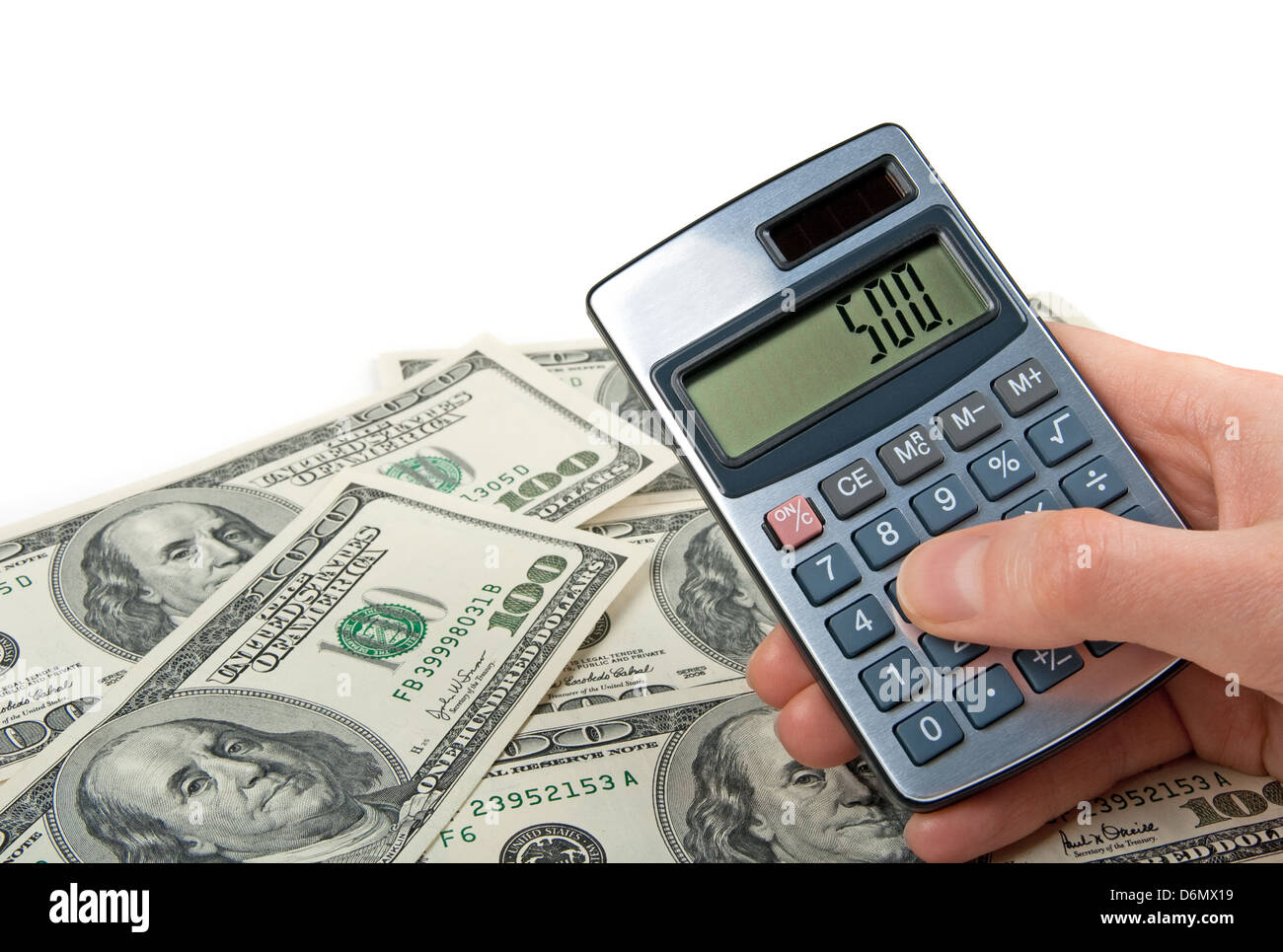 American dollars and female hand holding a calculator, on white ...