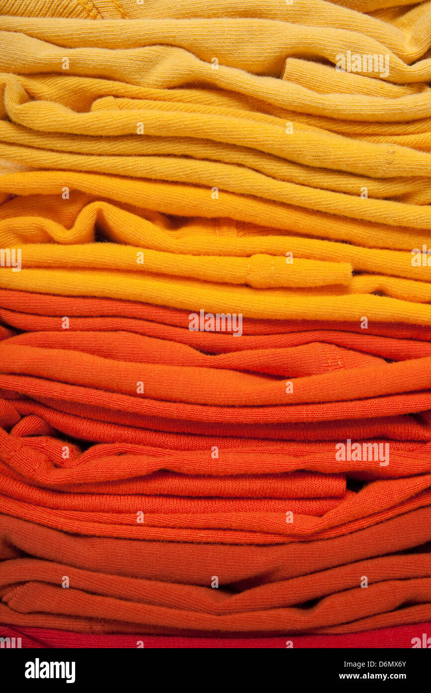 Warm colors background. Folded red, orange and yellow clothes Stock ...