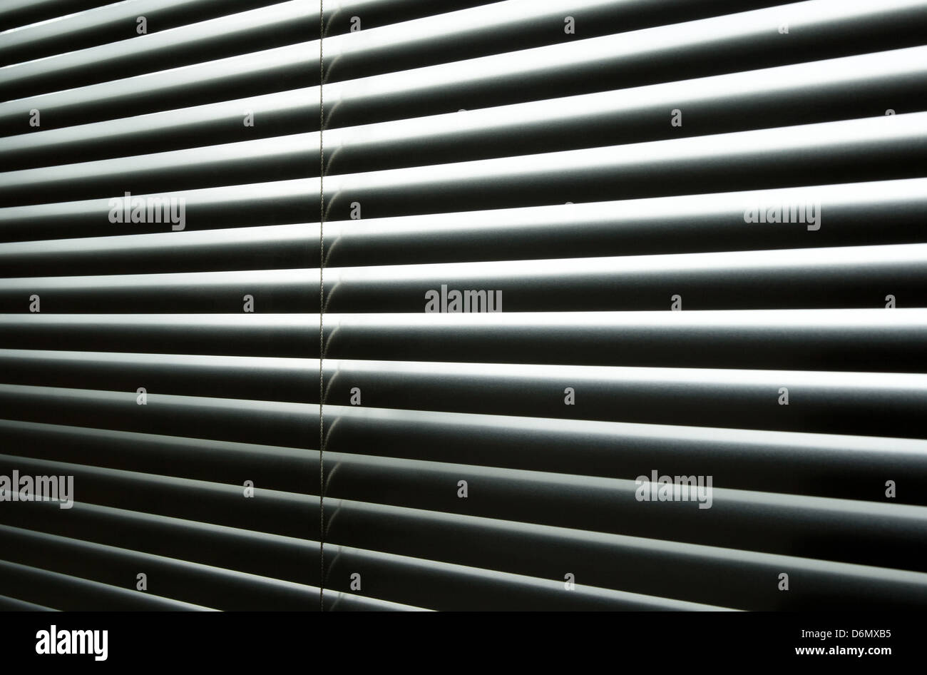 Daylight coming through closed metallic blinds, high-contrast abstract ...