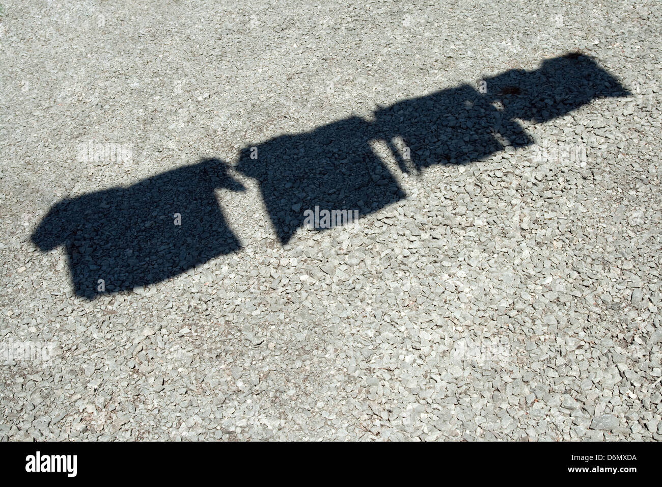 Shadow of clothes hanging to dry on a laundry line Stock Photo - Alamy