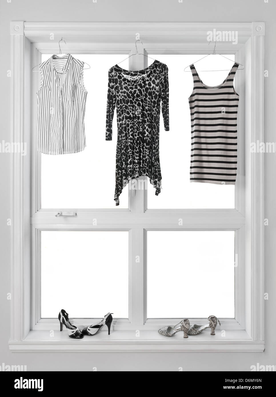 Black and white clothes hanging in the window Stock Photo - Alamy