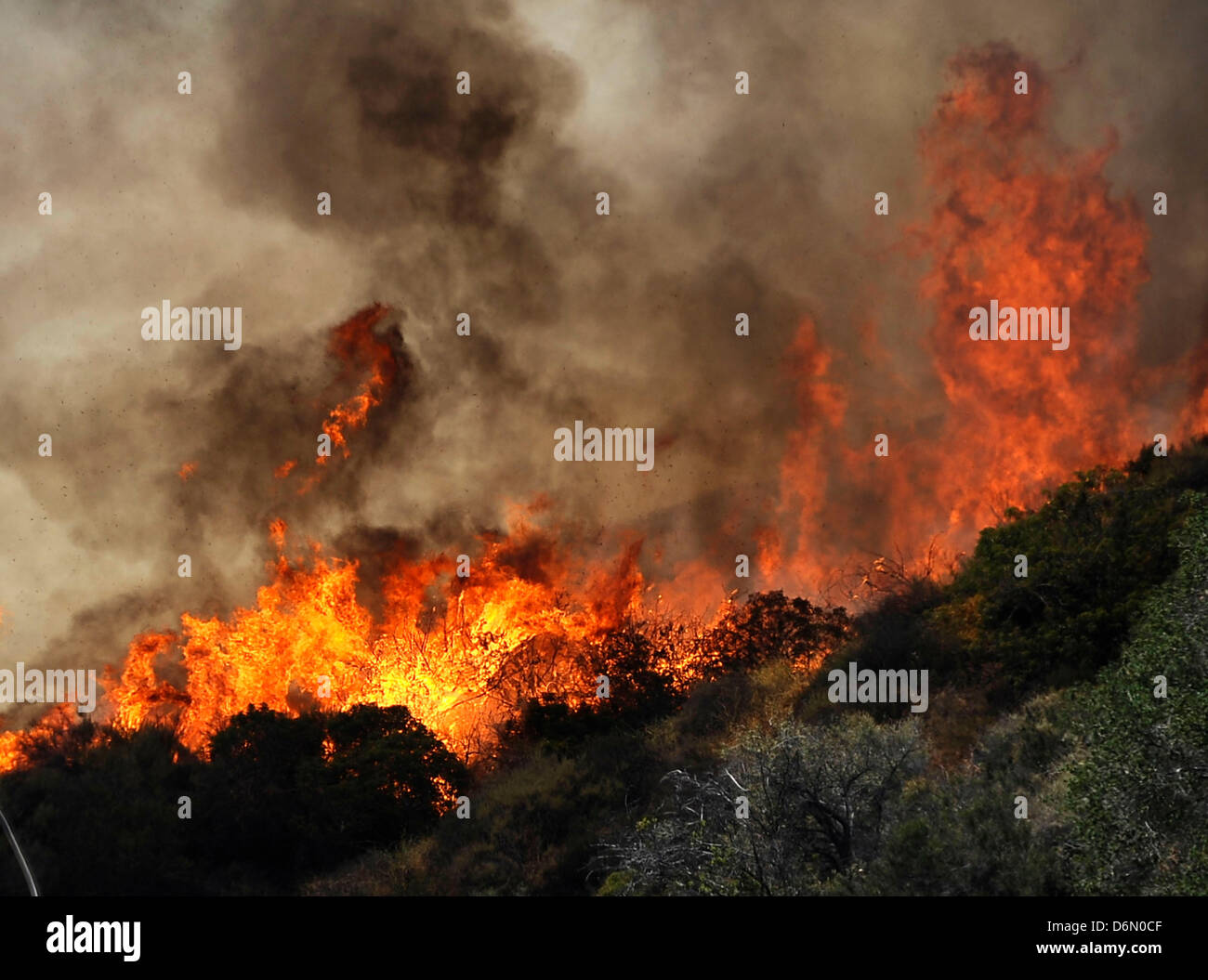 Monrovia. 20th April, 2013. Firefighters battle form the air a brush ...