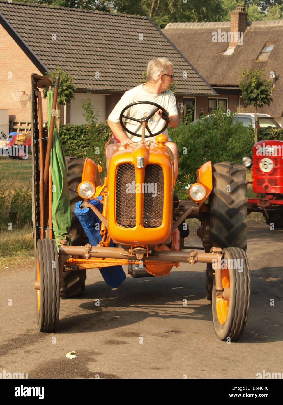 The Orange FIAT tractor is a compact agricultural machine produced by ...