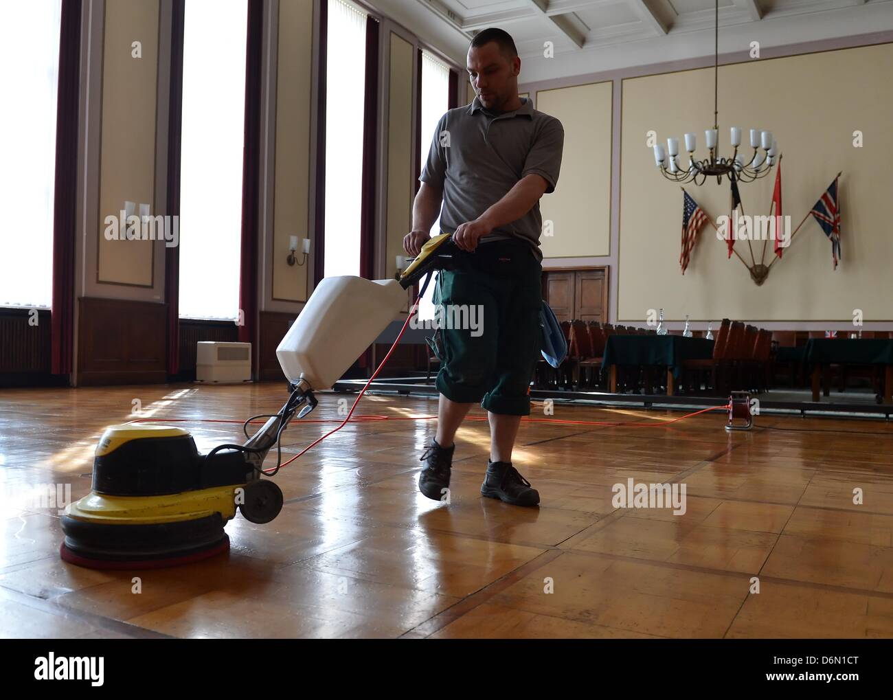 An employee polishes the floor of the Hall of Capitulation at the ...
