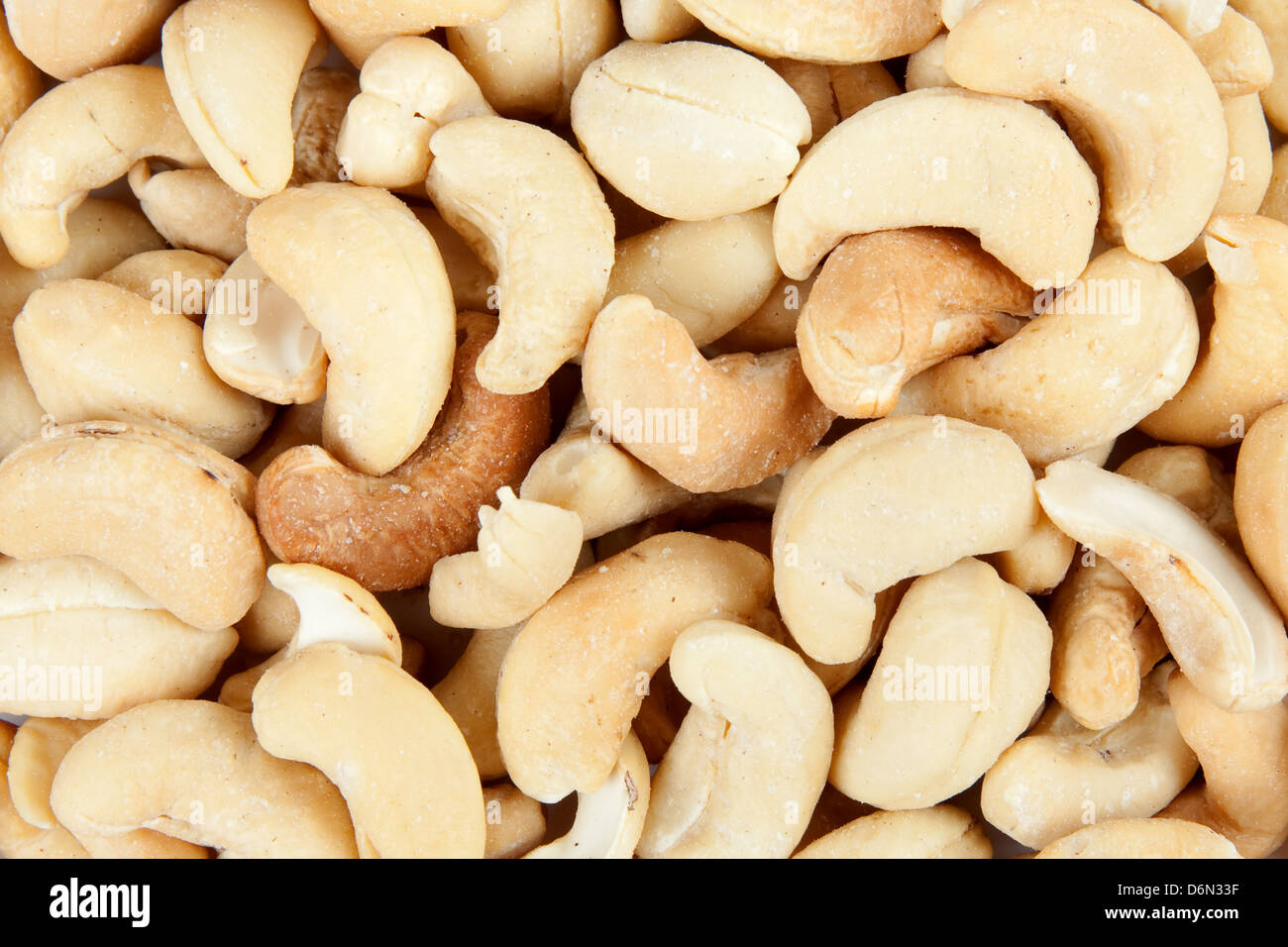 Fresh salted cashews texture background Stock Photo - Alamy