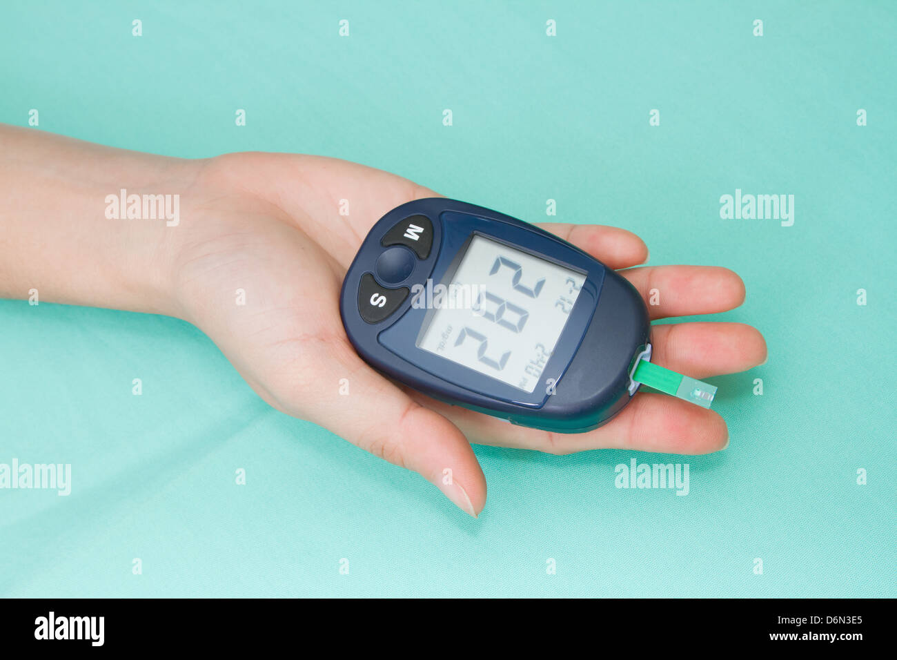 Hand with glucometer Stock Photo - Alamy