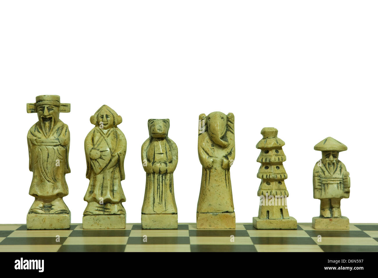 Display of white pieces of a stone chess set on a wood chess board ...