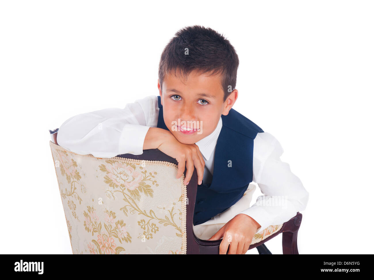 Beautiful smiling boy sitting on a chair Stock Photo - Alamy