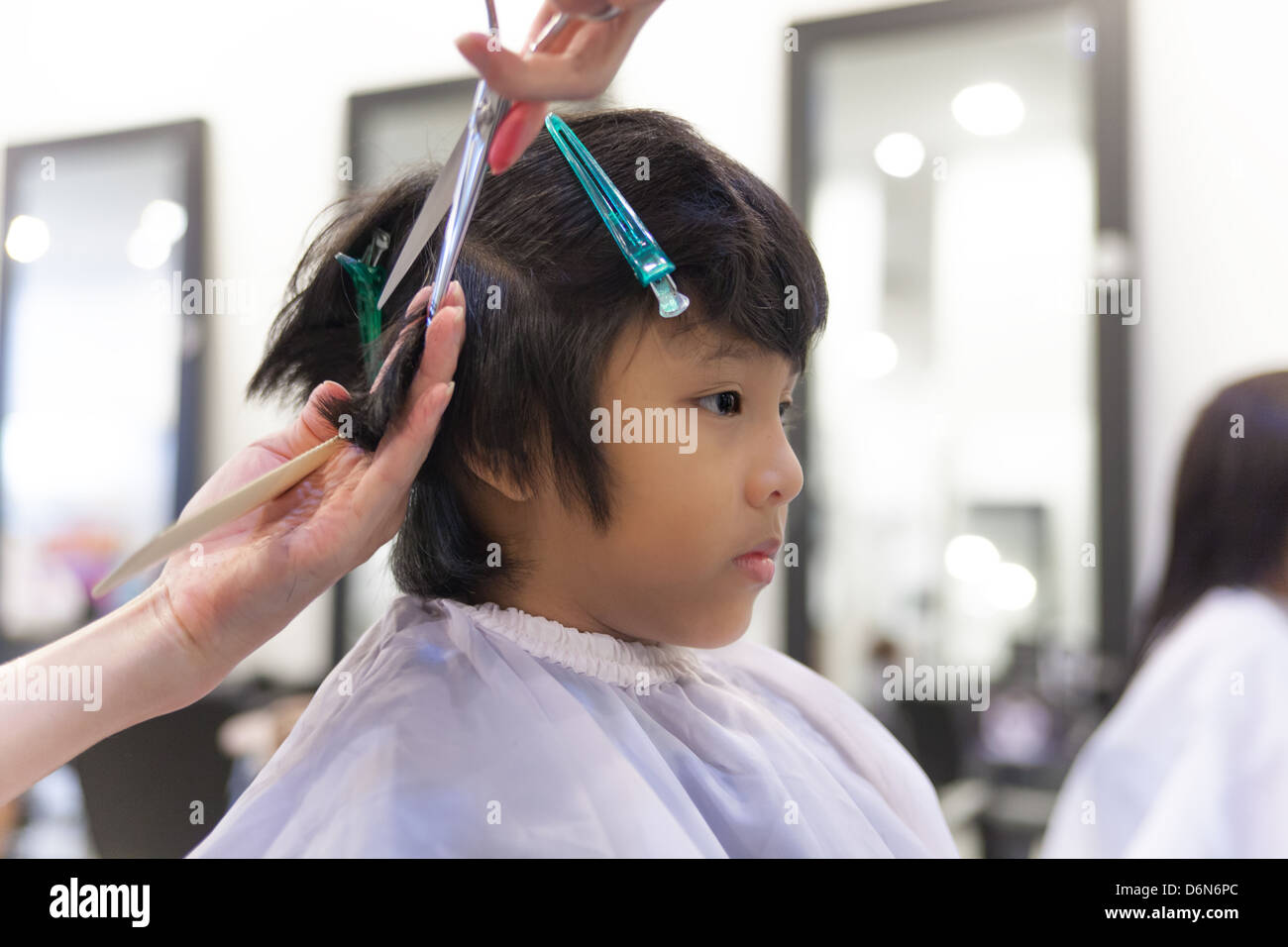 A young boy getting haircut in hair salon Stock Photo - Alamy