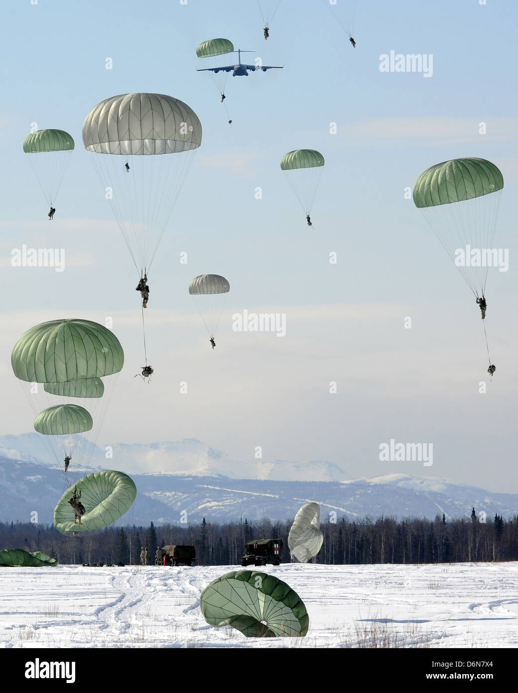 US Army paratrooper soldiers parachute during an airdrop exercise April ...