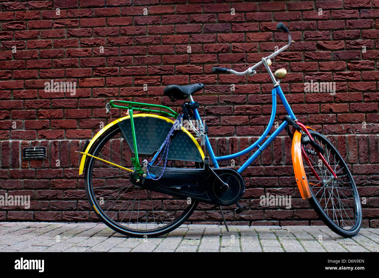 Colorful bicycle in front of a wall of bricks Stock Photo - Alamy