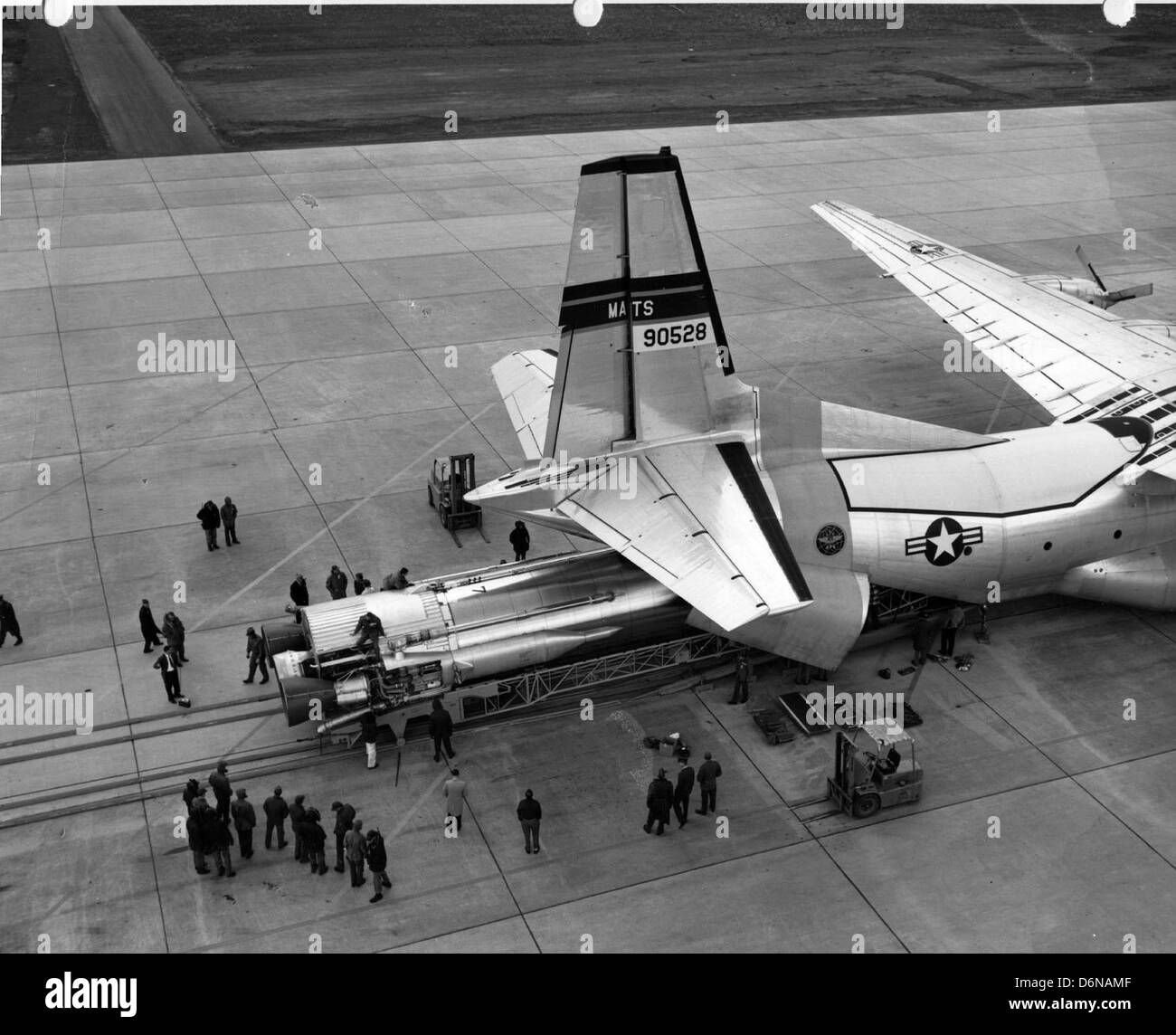 This image shows the Atlas missile being transported by a C-133 ...